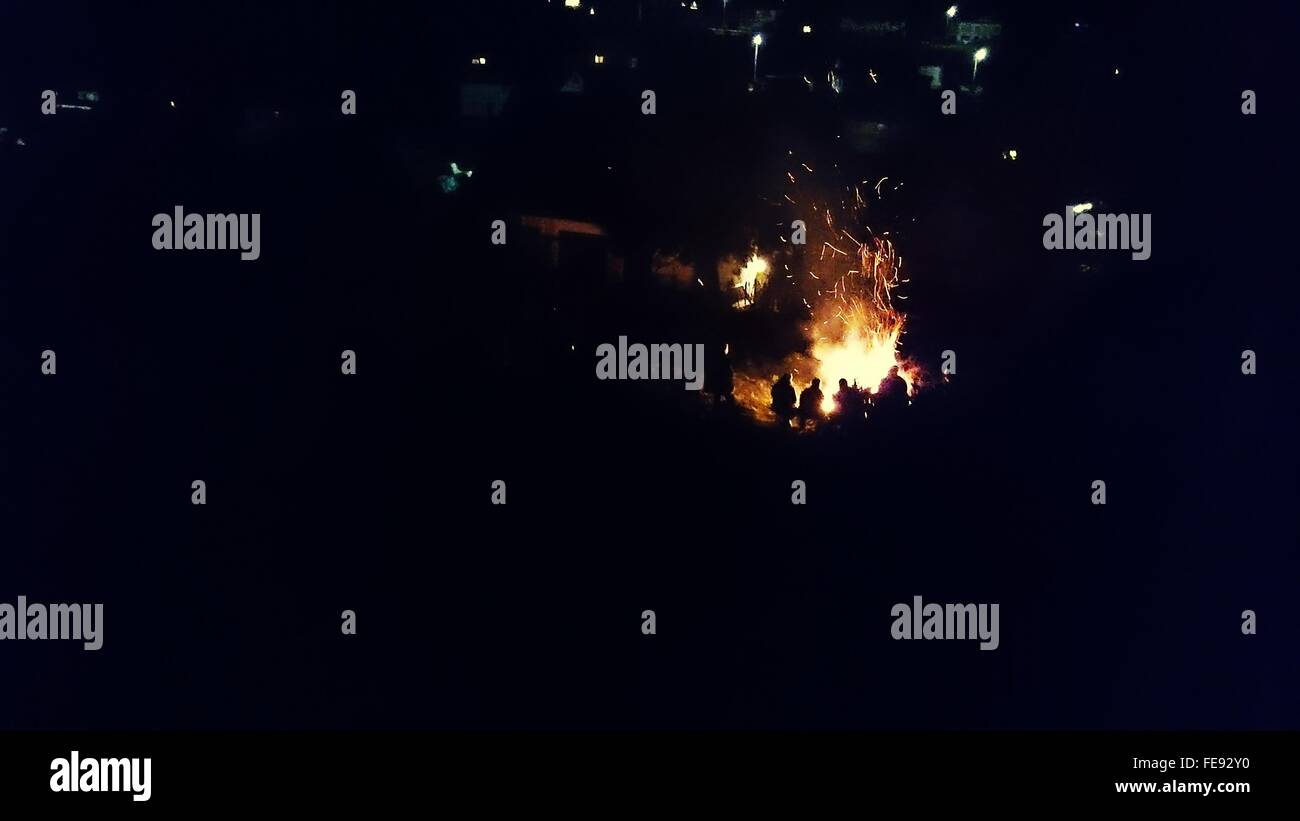 Friends Sitting By Fire Stock Photo - Alamy