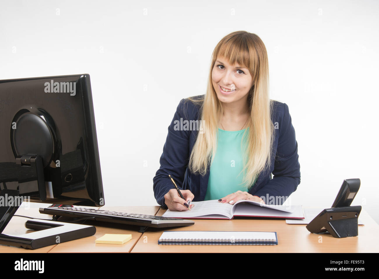 Young business woman secretary sitting at office desk working, isolated ...