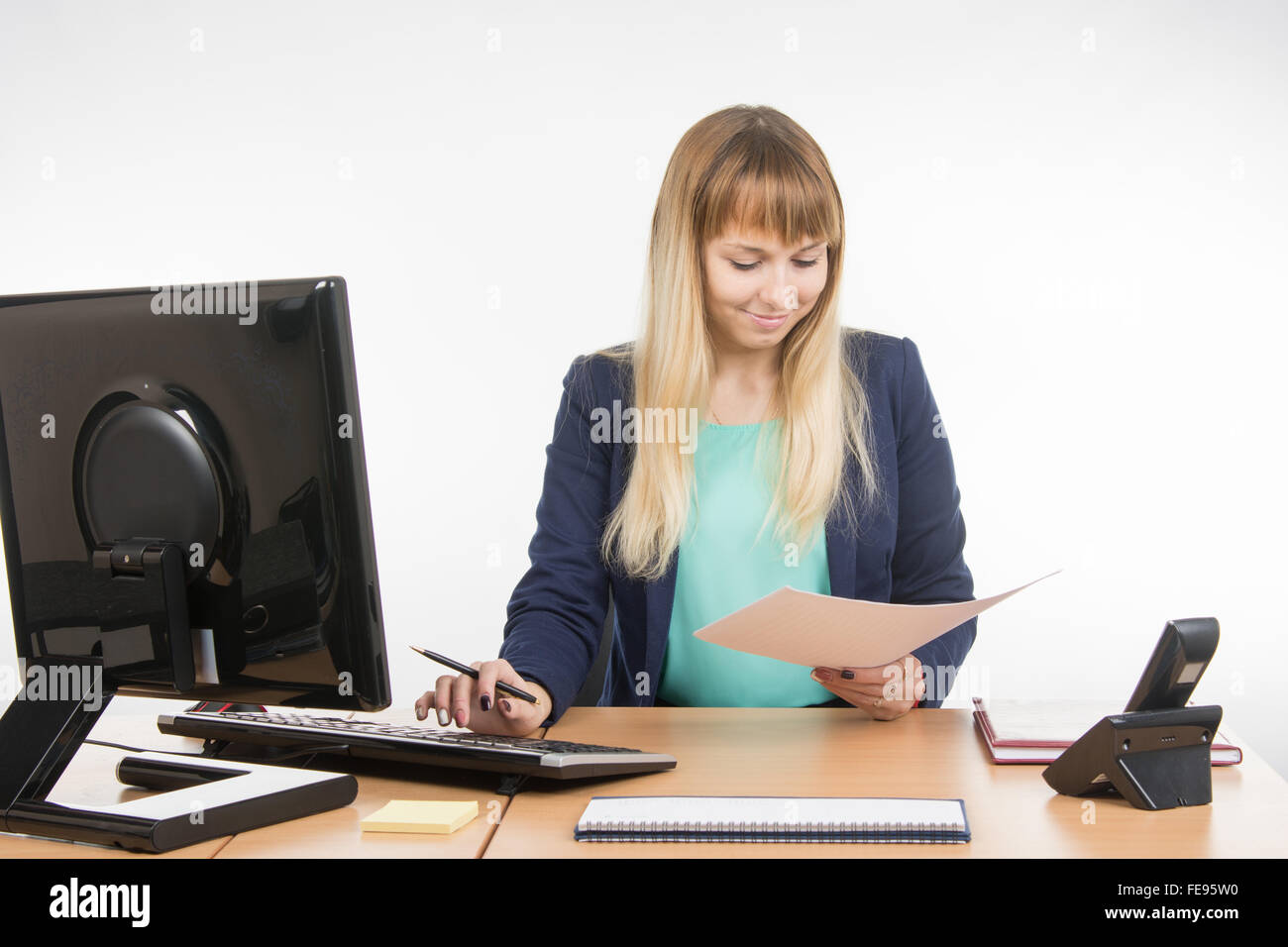 Young business woman secretary sitting at office desk working, isolated ...