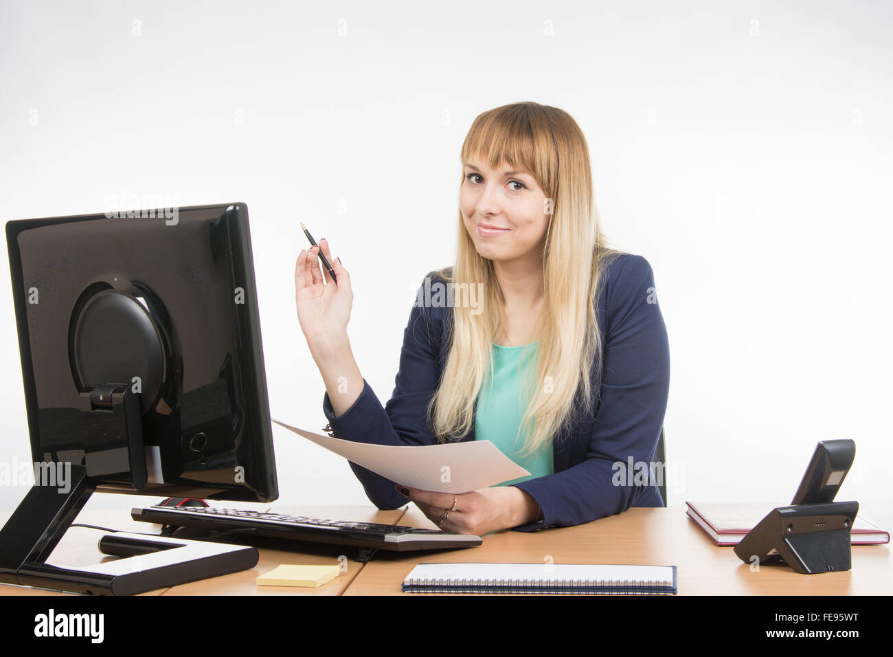 Young business woman secretary sitting at office desk working, isolated ...