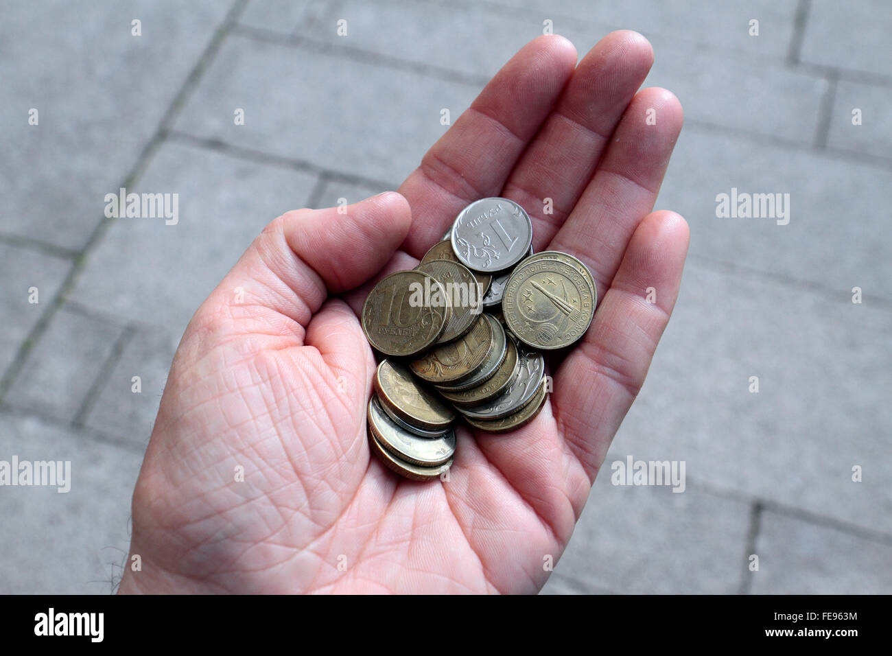 A hand holding a mixture of Russian ruble coins (in August 2016 Stock ...