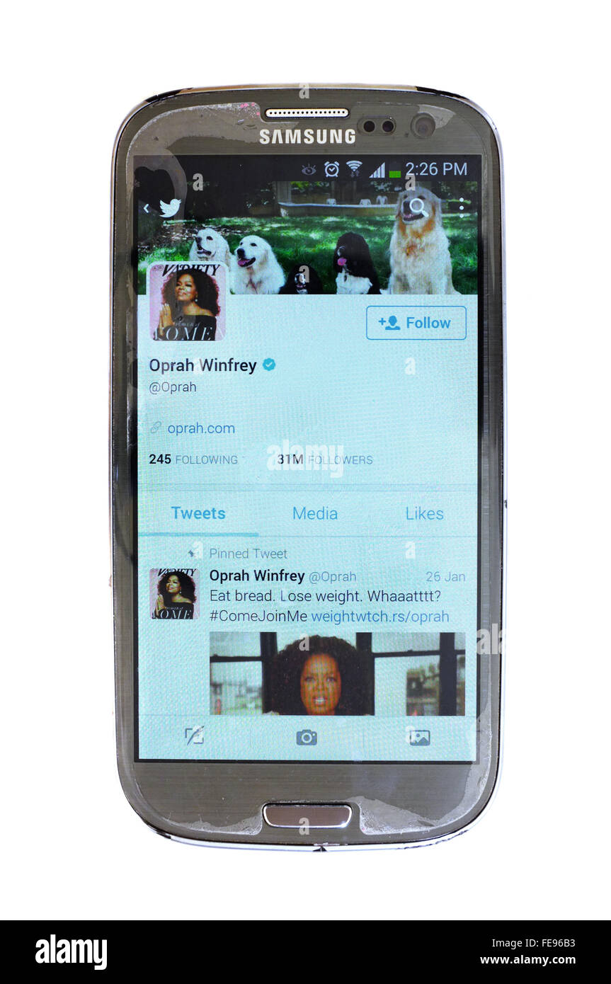 Oprah's twitter account on a smartphone screen photographed against a ...