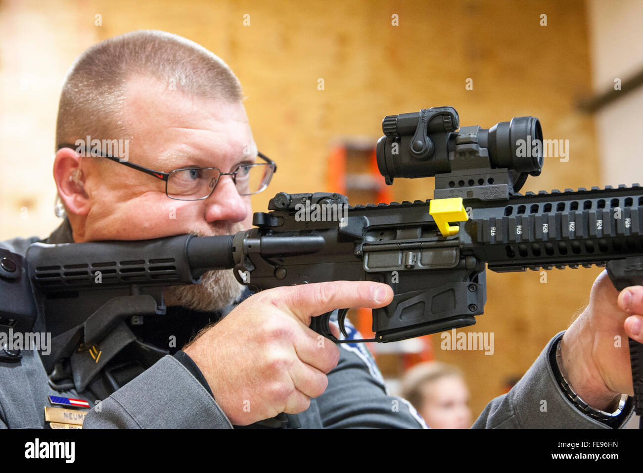 Police Officer with a weapon marked for safety during a training ...