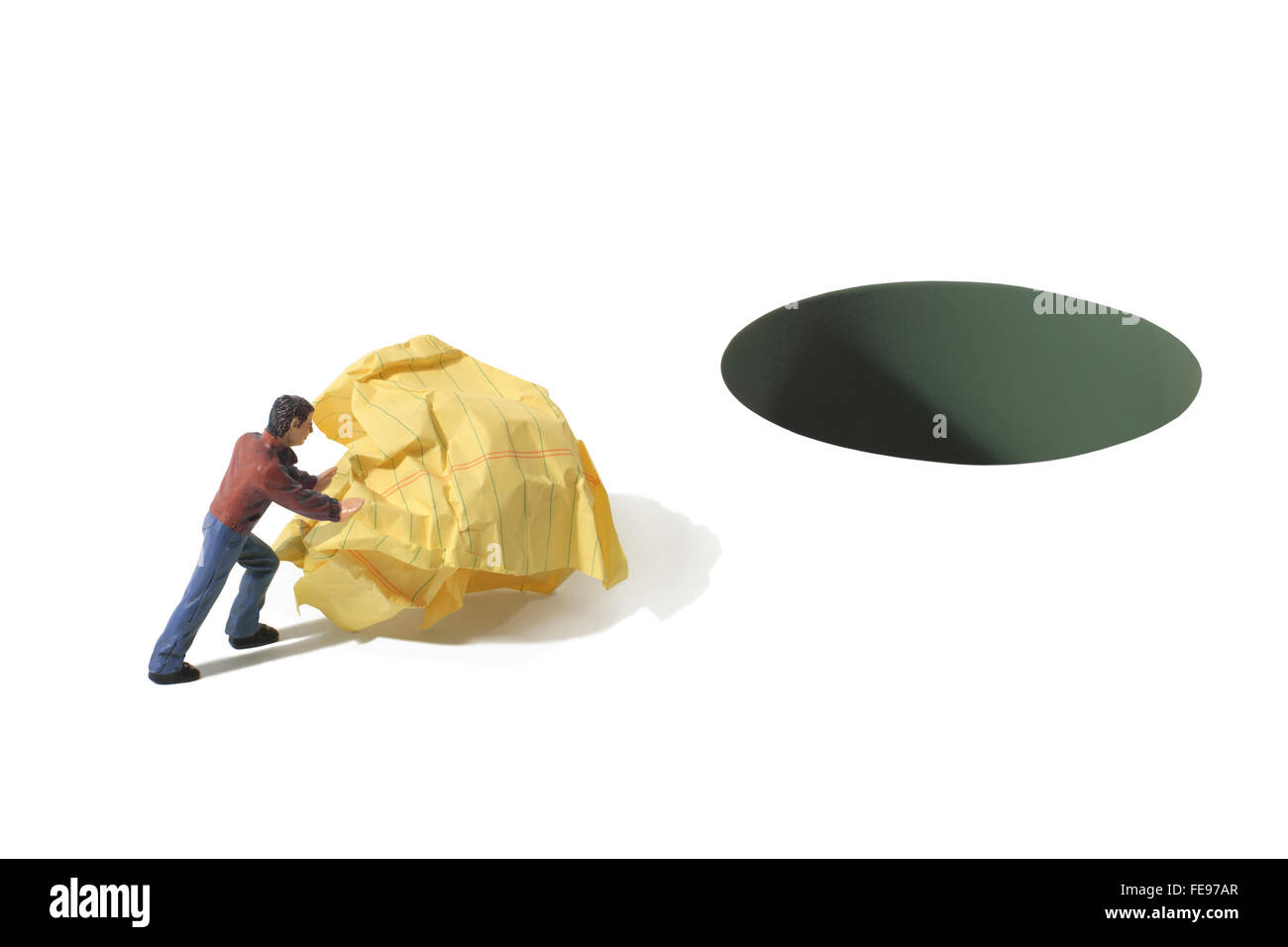 Figure Pushing Paper Wad Into a Hole on a White Background Stock Photo ...