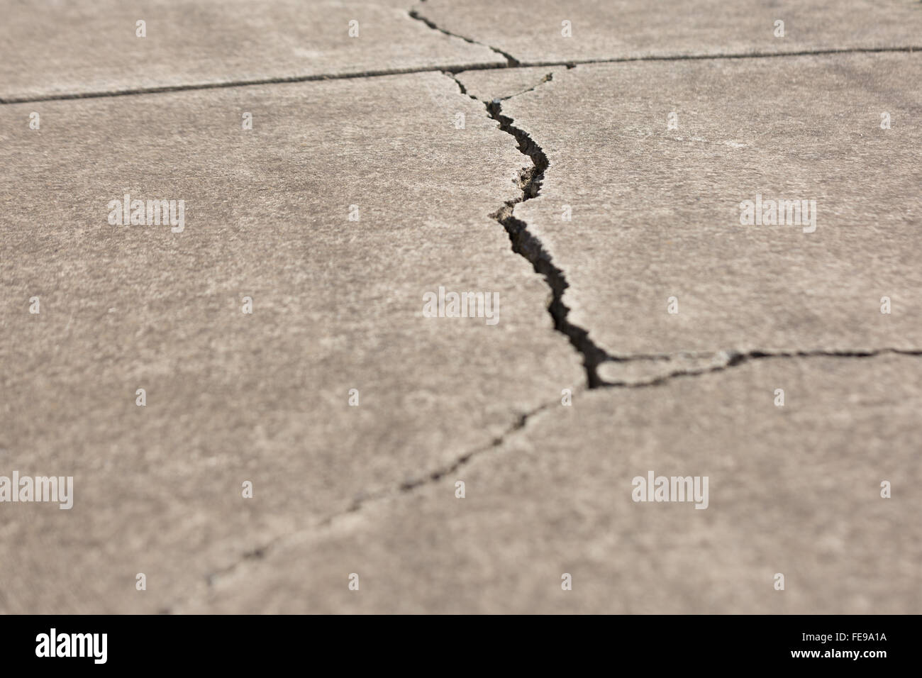 A Large crack in concrete pathway Stock Photo - Alamy