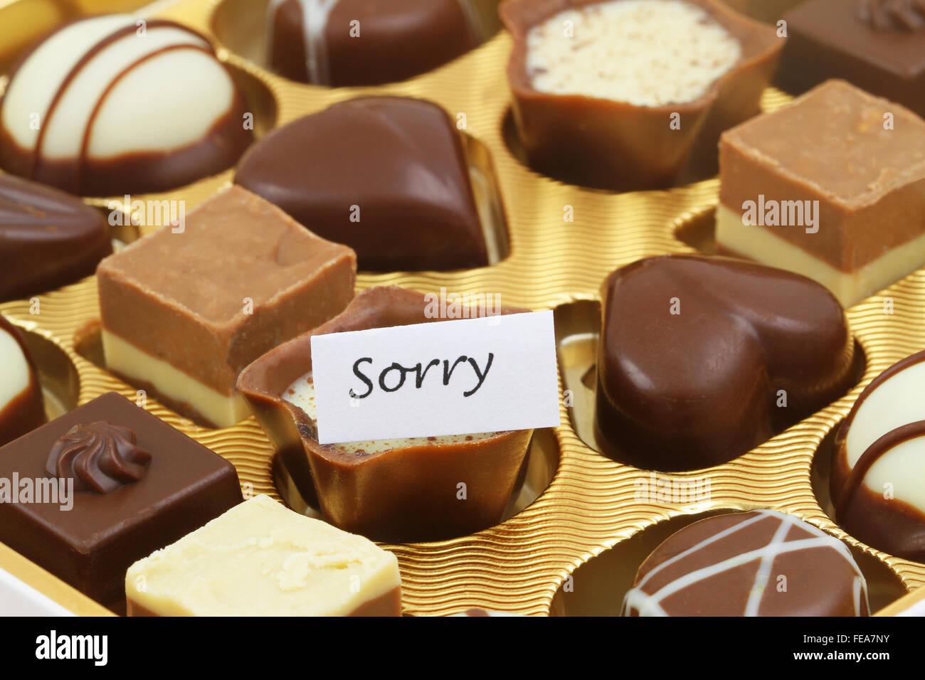 Sorry card with box of assorted chocolates Stock Photo - Alamy
