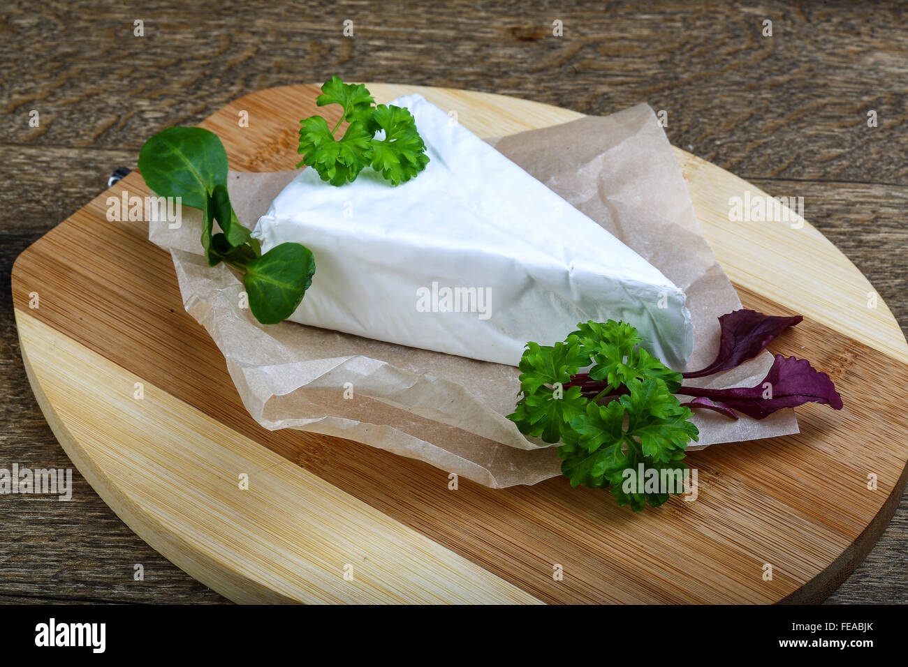 Soft brie cheese served parsley leaves on wooden background Stock Photo ...