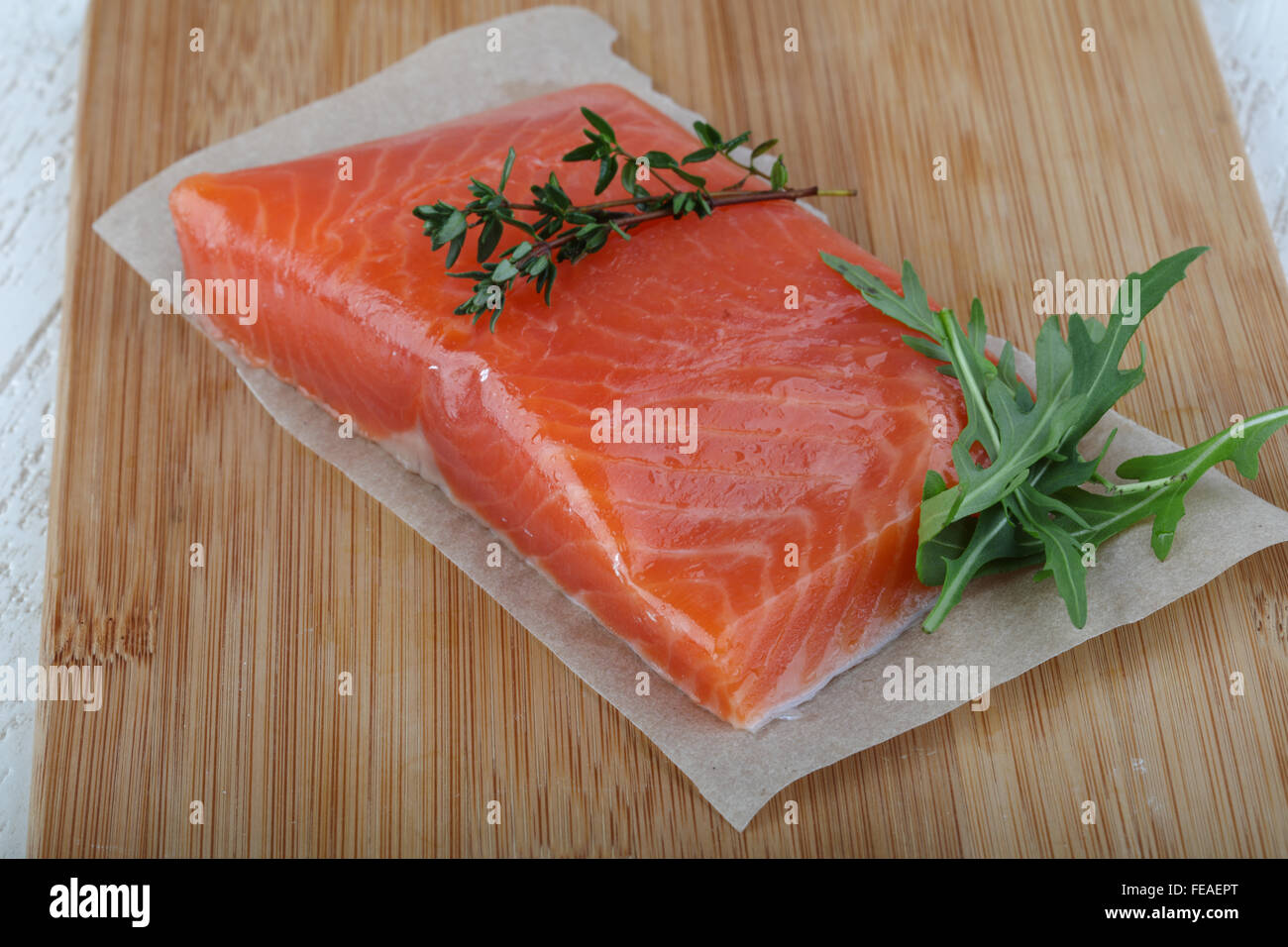 Salted salmon with thyme leaves on the wood background Stock Photo - Alamy