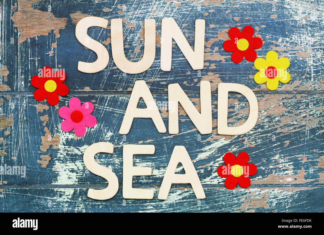 Sun and sea written with wooden letters on rustic surface and colorful ...
