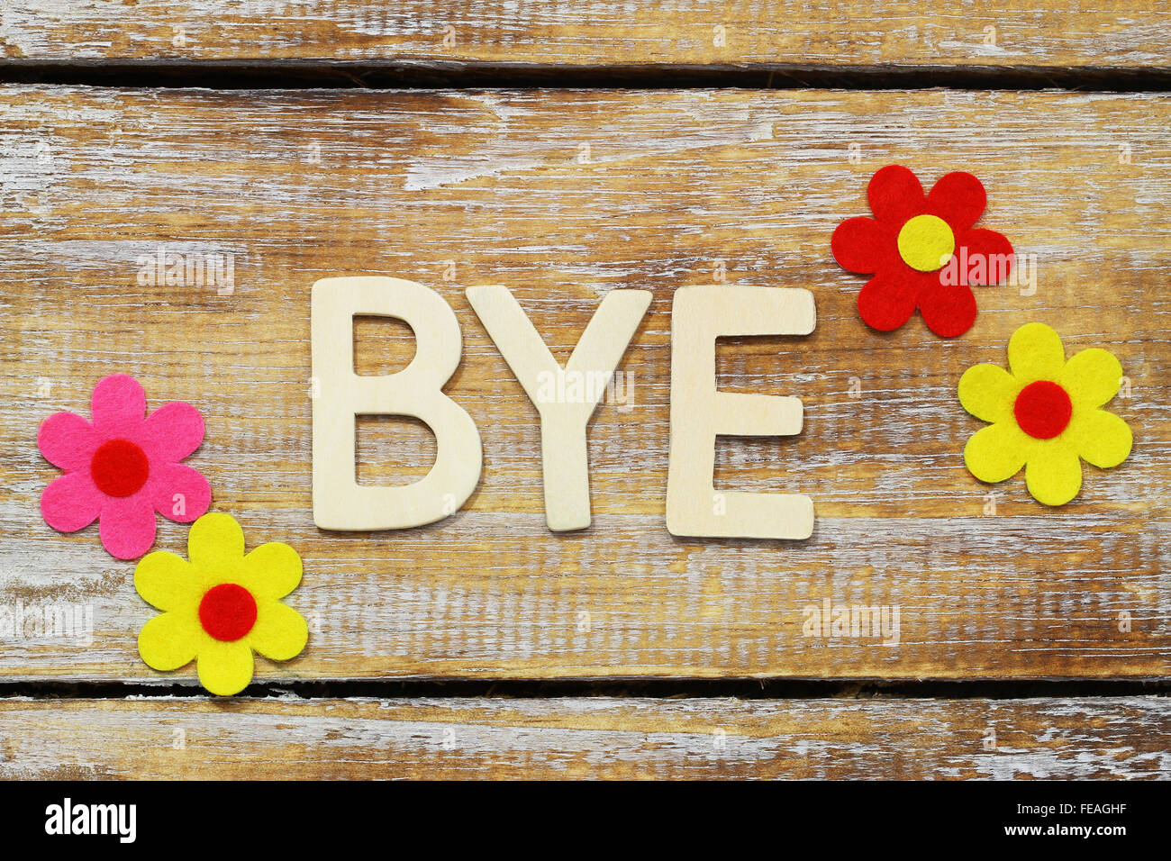 Word bye written with wooden letters on rustic surface and colorful ...