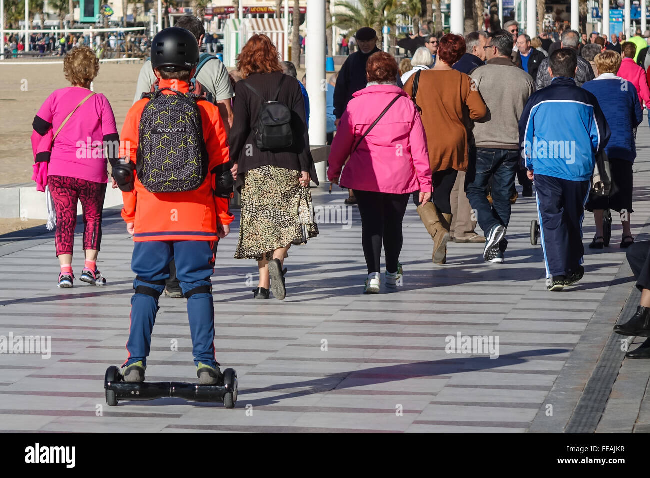 Young man riding a hoverboard on the promenade in Benidorn, Spain Stock ...