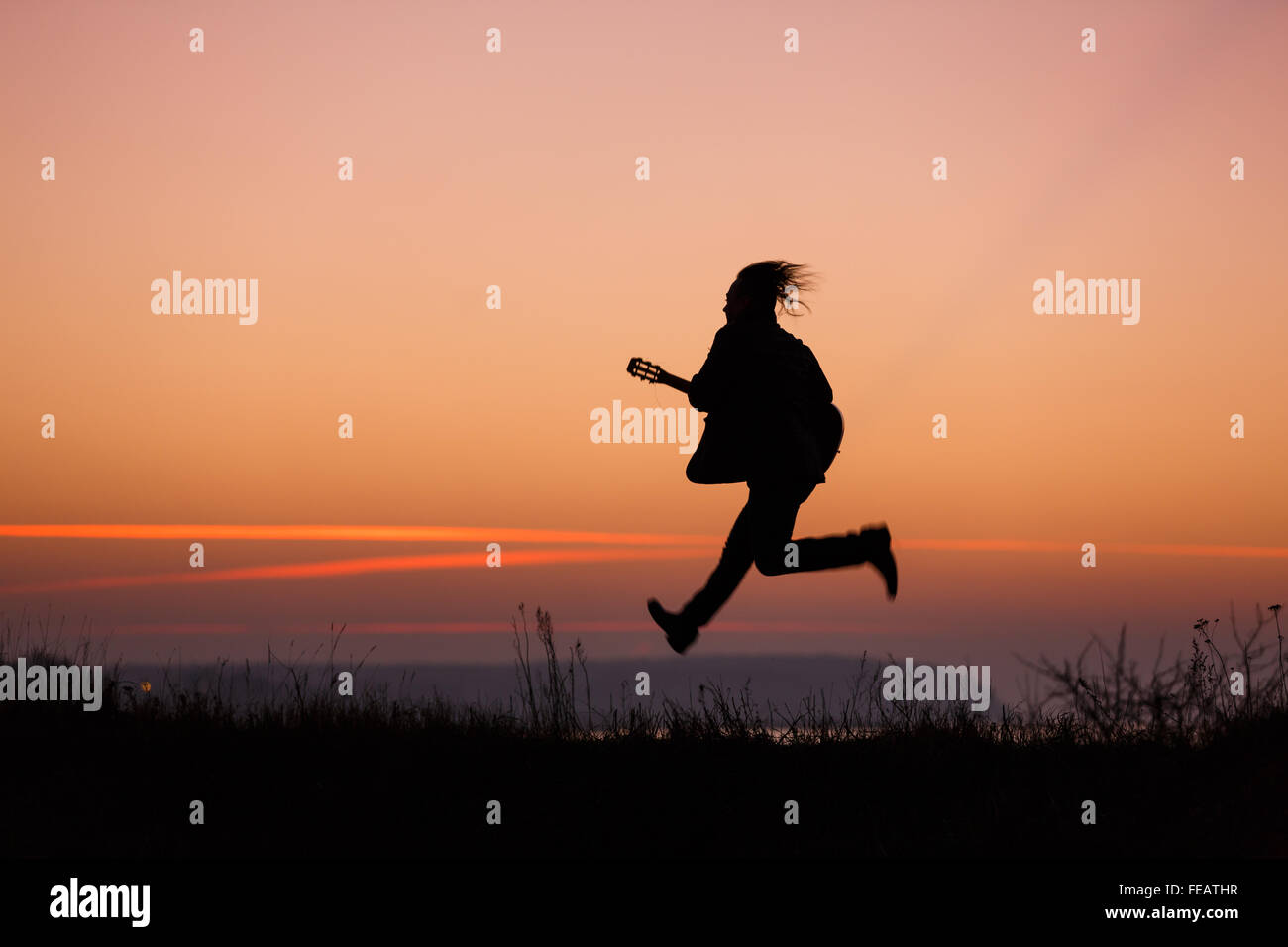 Silhouette jumping man sunset hi-res stock photography and images - Alamy