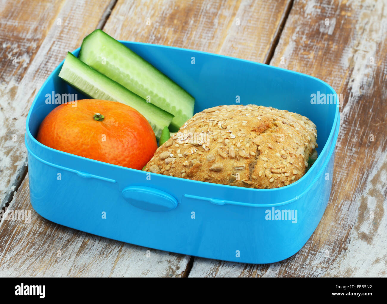 Healthy lunch box containing mixed grain cheese roll, cucumbers sticks ...