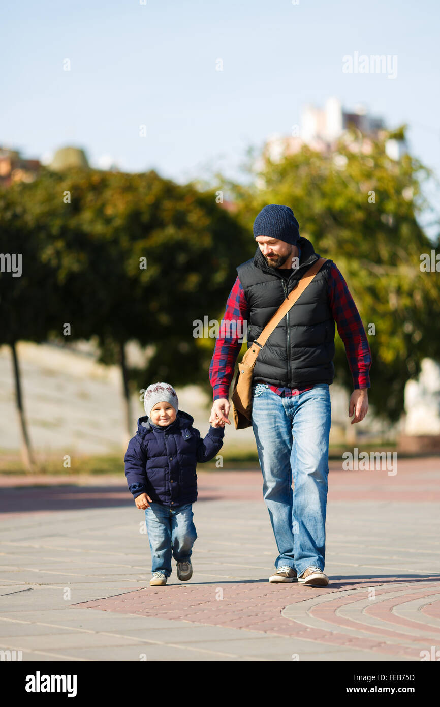 Father and son walking in the city at autumn time Stock Photo - Alamy