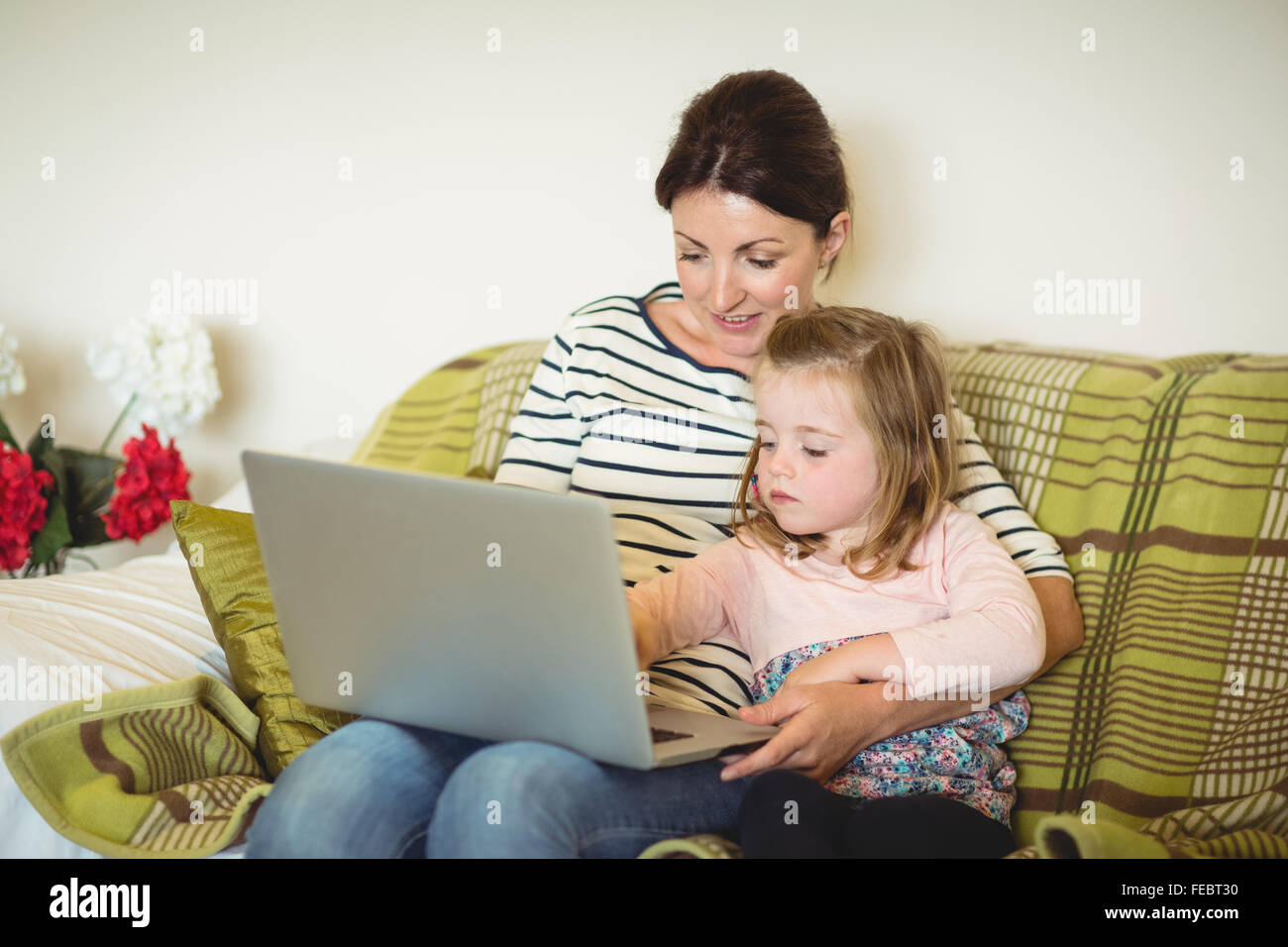 Mother and daughter using laptop Stock Photo - Alamy