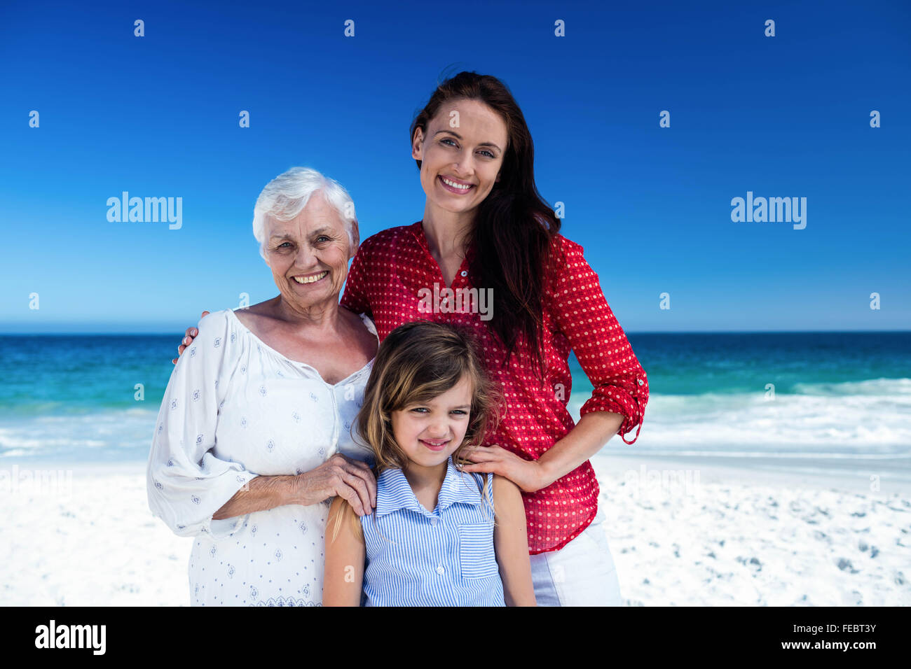 Multi generation family standing and smiling Stock Photo - Alamy