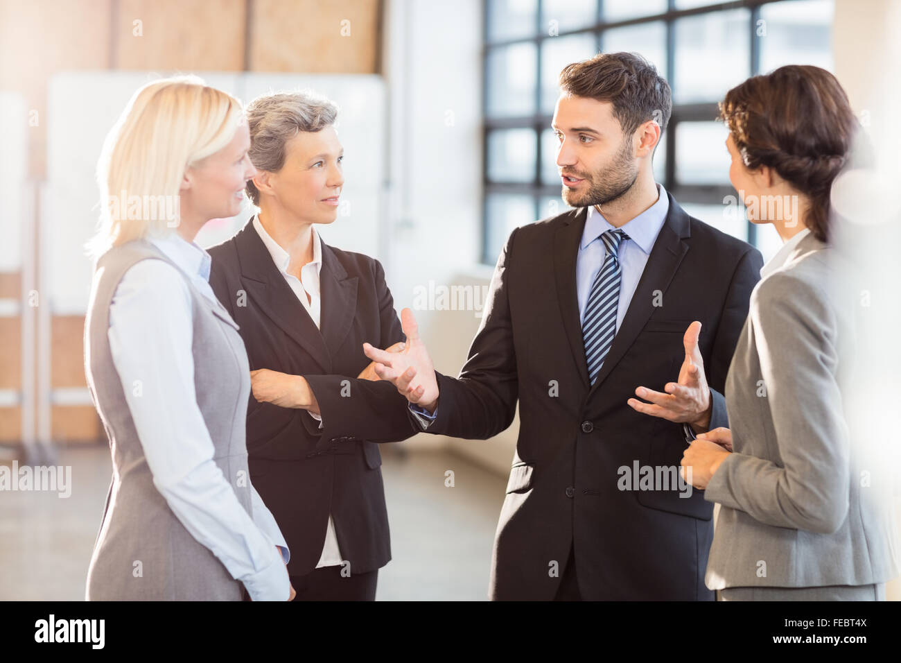 Business team standing and speaking Stock Photo - Alamy