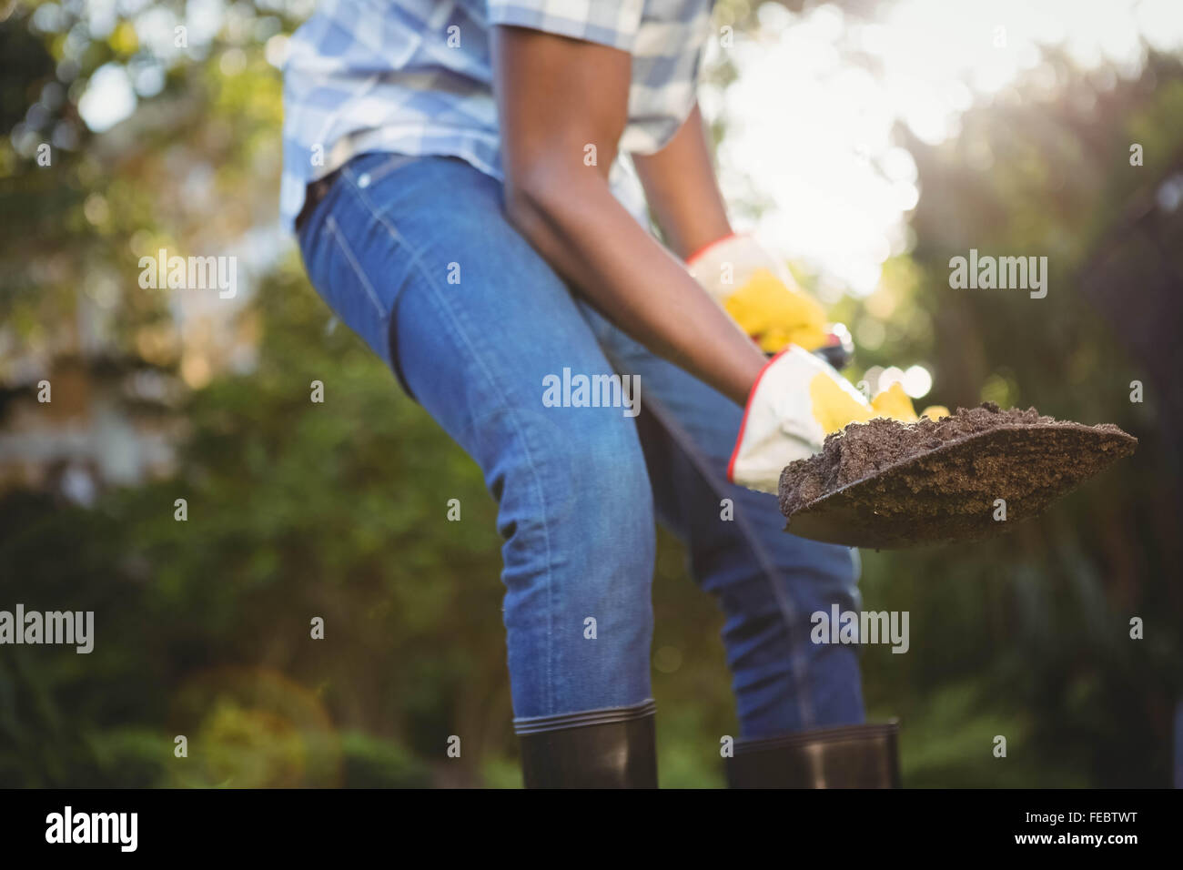 Handsome man digging with a shovel Stock Photo - Alamy