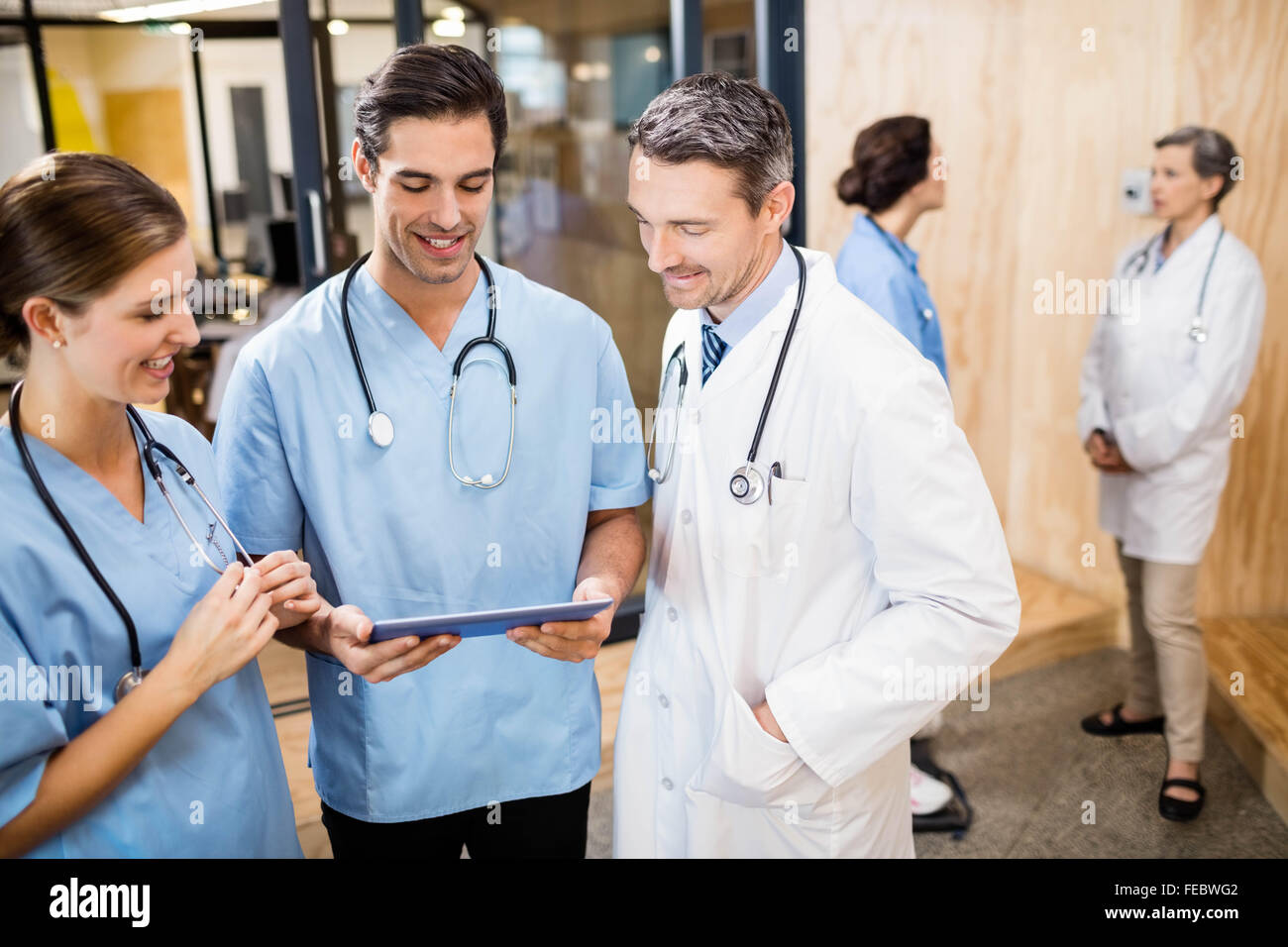 Medical team standing and talking Stock Photo - Alamy