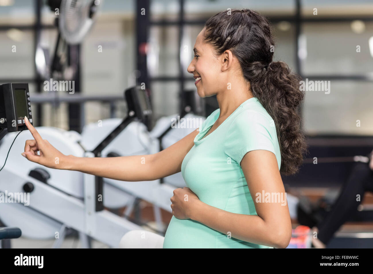 Smiling woman setting exercise Stock Photo - Alamy