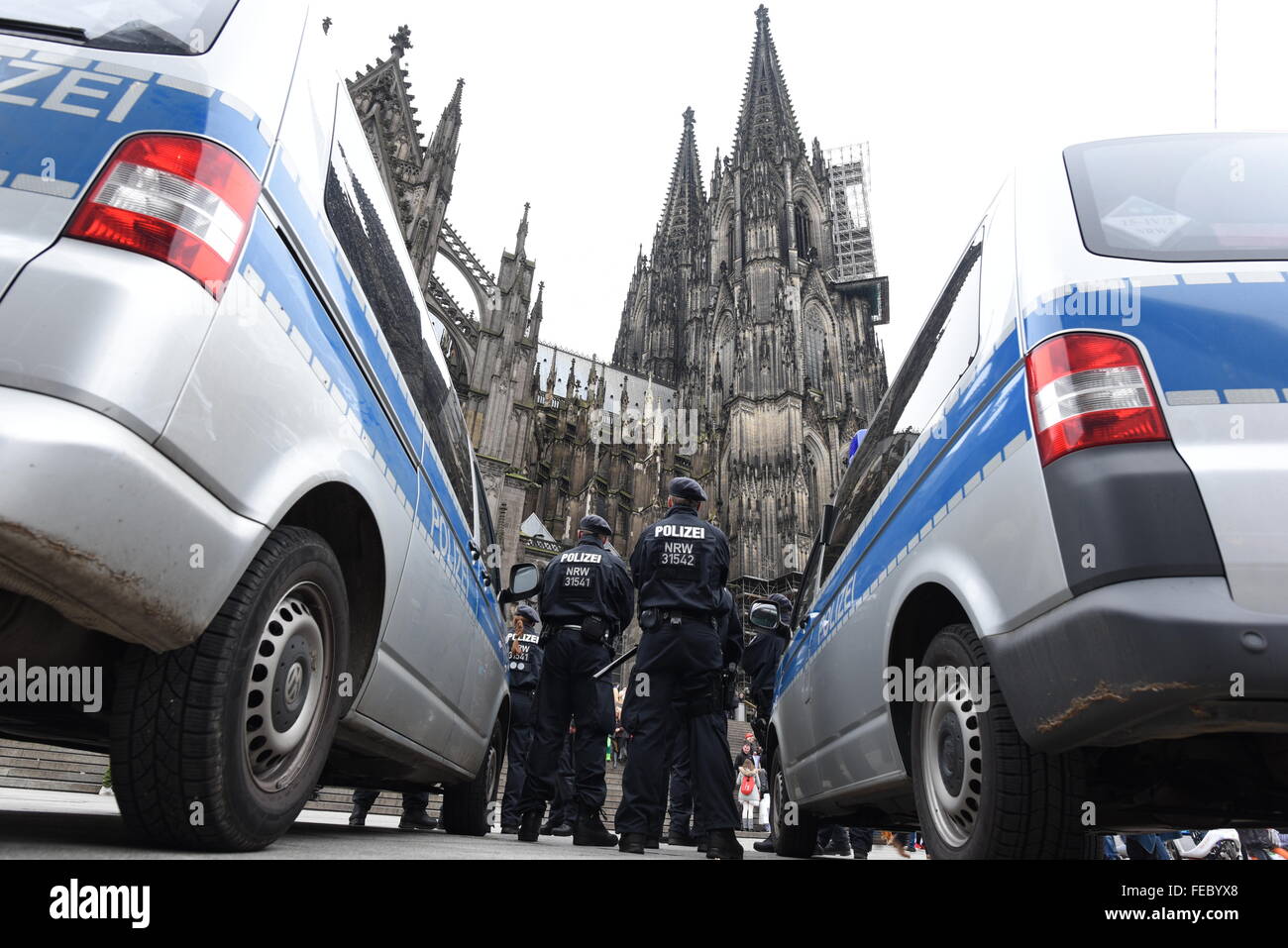 Cologne, Germany. 4th Feb, 2016. Police officer and marked police cars ...