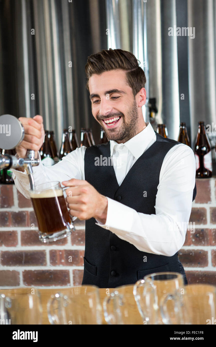 Barman pouring beer Stock Photo - Alamy