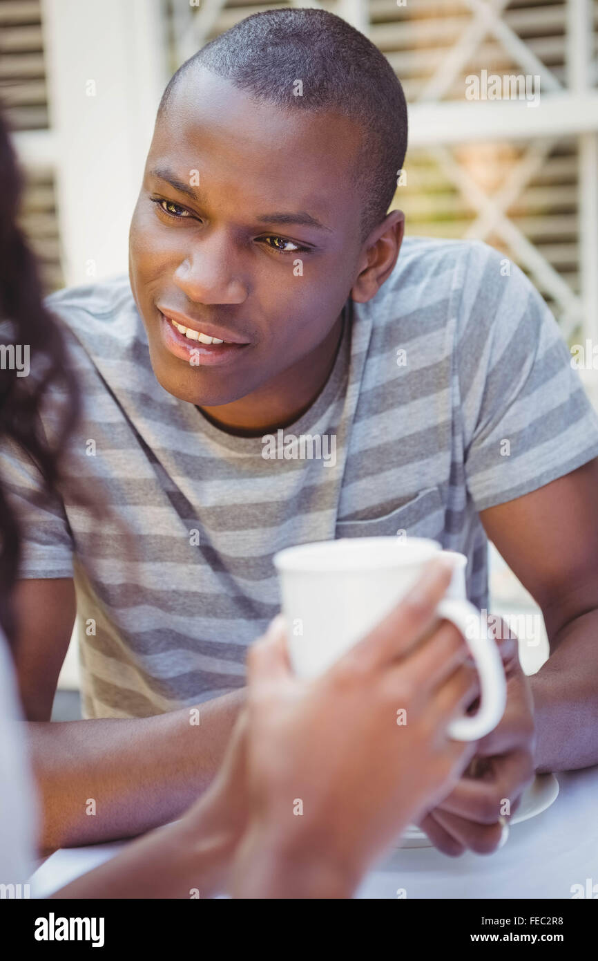 Handsome man having a mug of tea with his girlfriend Stock Photo - Alamy