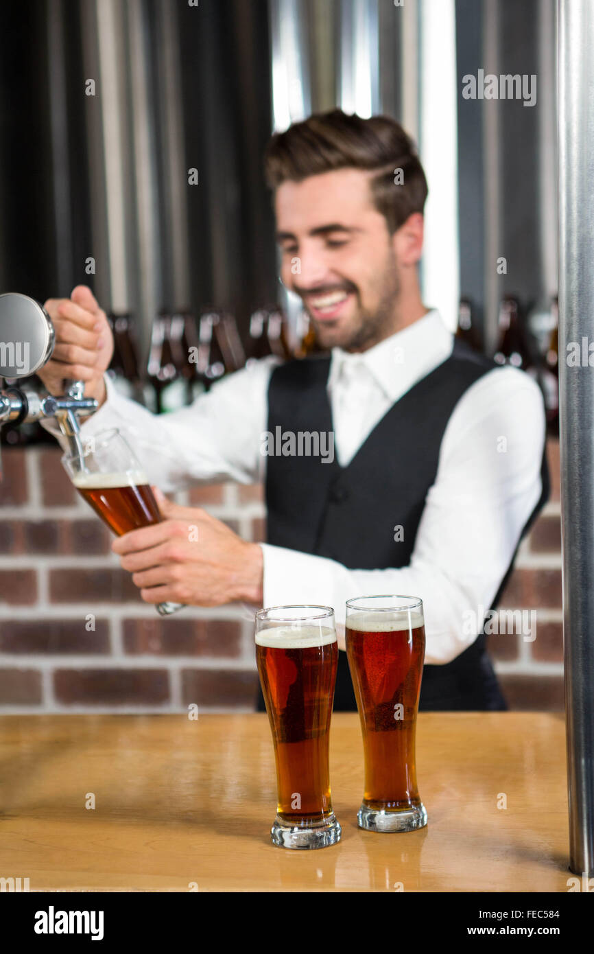 Barman pouring a beer Stock Photo - Alamy
