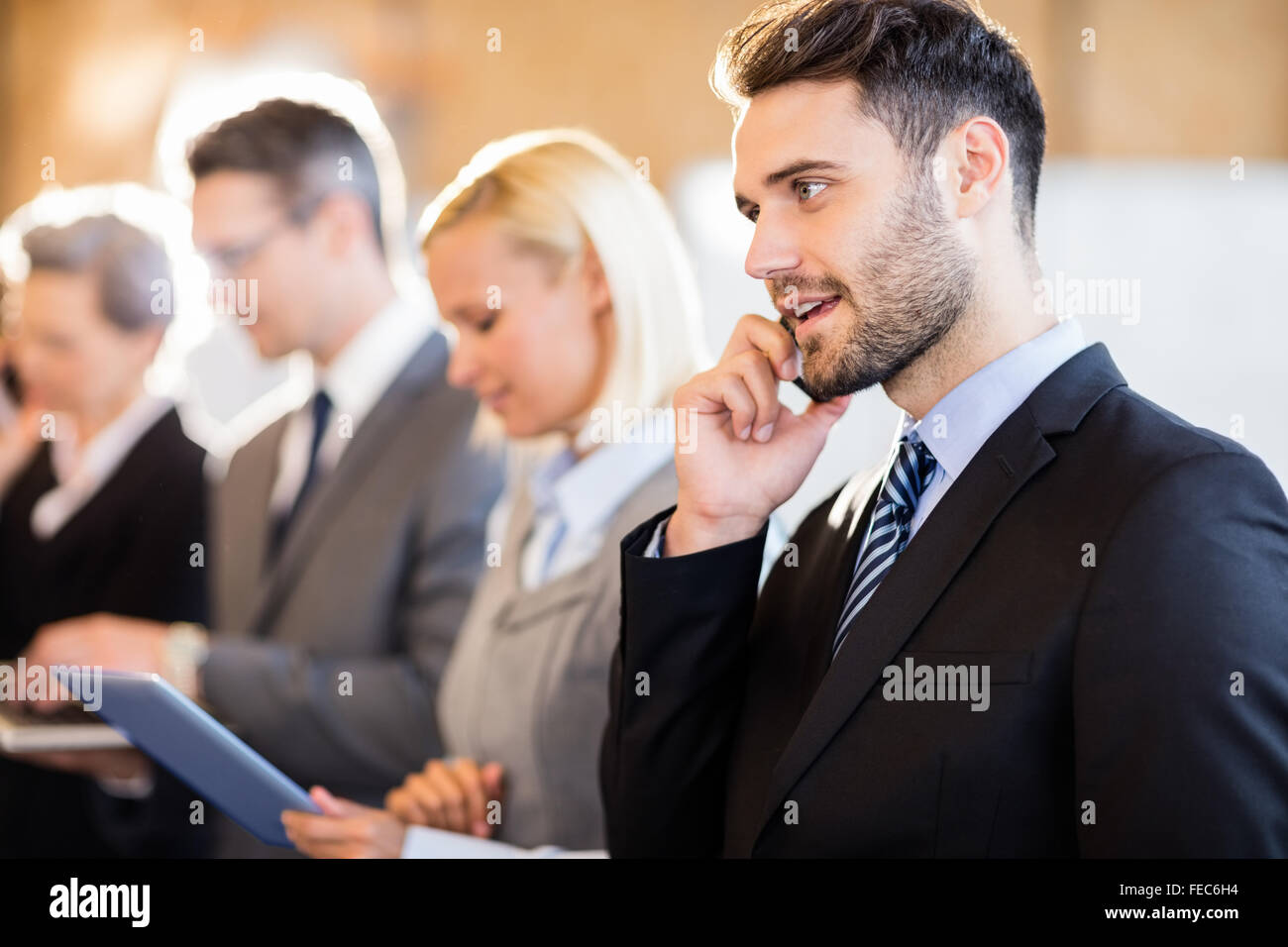Business team using their media devices Stock Photo - Alamy