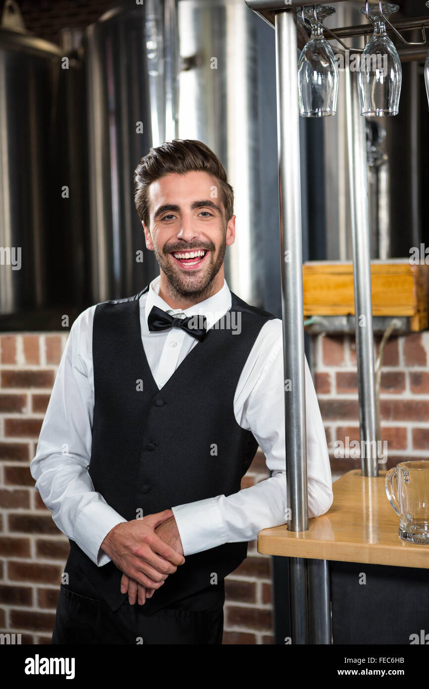 Handsome barman smiling at camera Stock Photo - Alamy