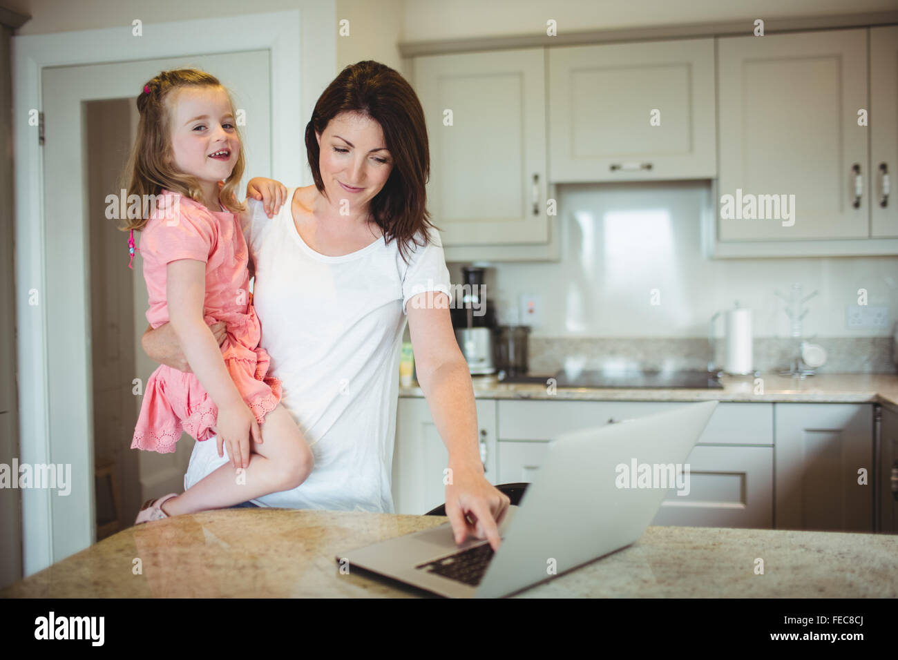 Mother and daughter using laptop Stock Photo - Alamy
