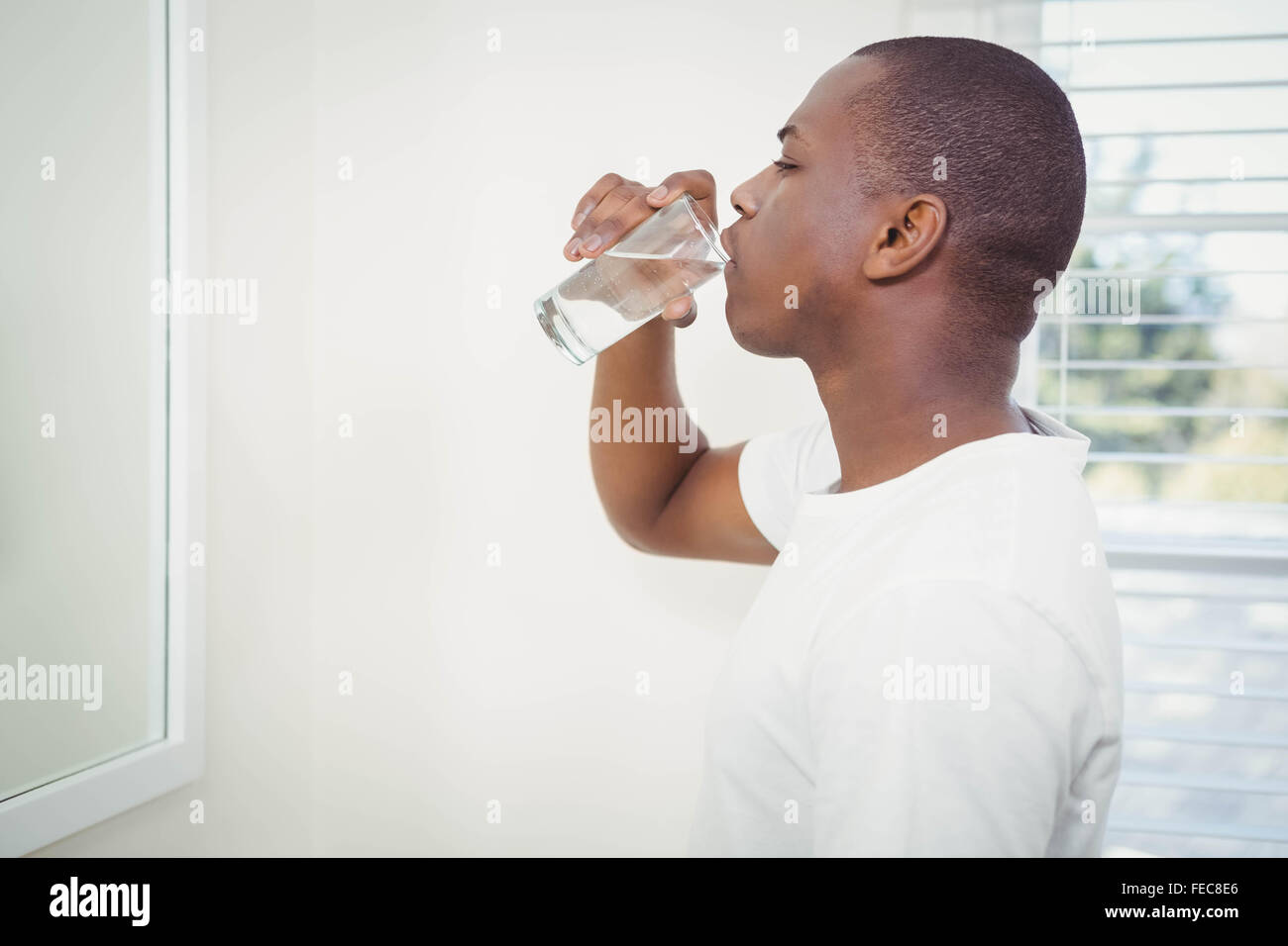 Handsome man drinking water Stock Photo - Alamy