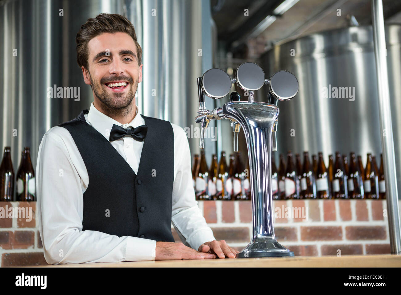 Handsome barman smiling at camera Stock Photo - Alamy