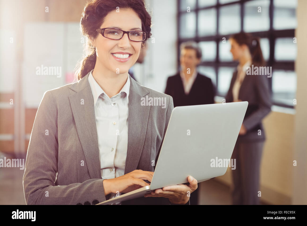 Businesswoman using her laptop Stock Photo - Alamy