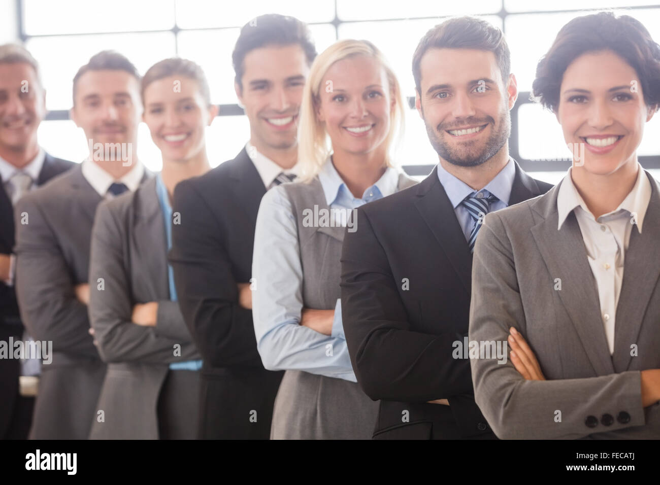 Business team smiling at the camera Stock Photo - Alamy