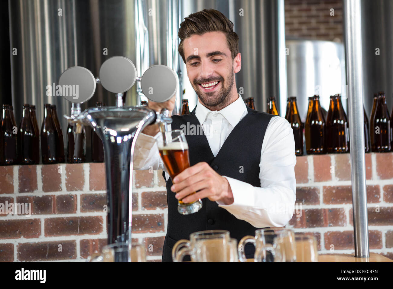 Handsome barman pouring a beer Stock Photo - Alamy