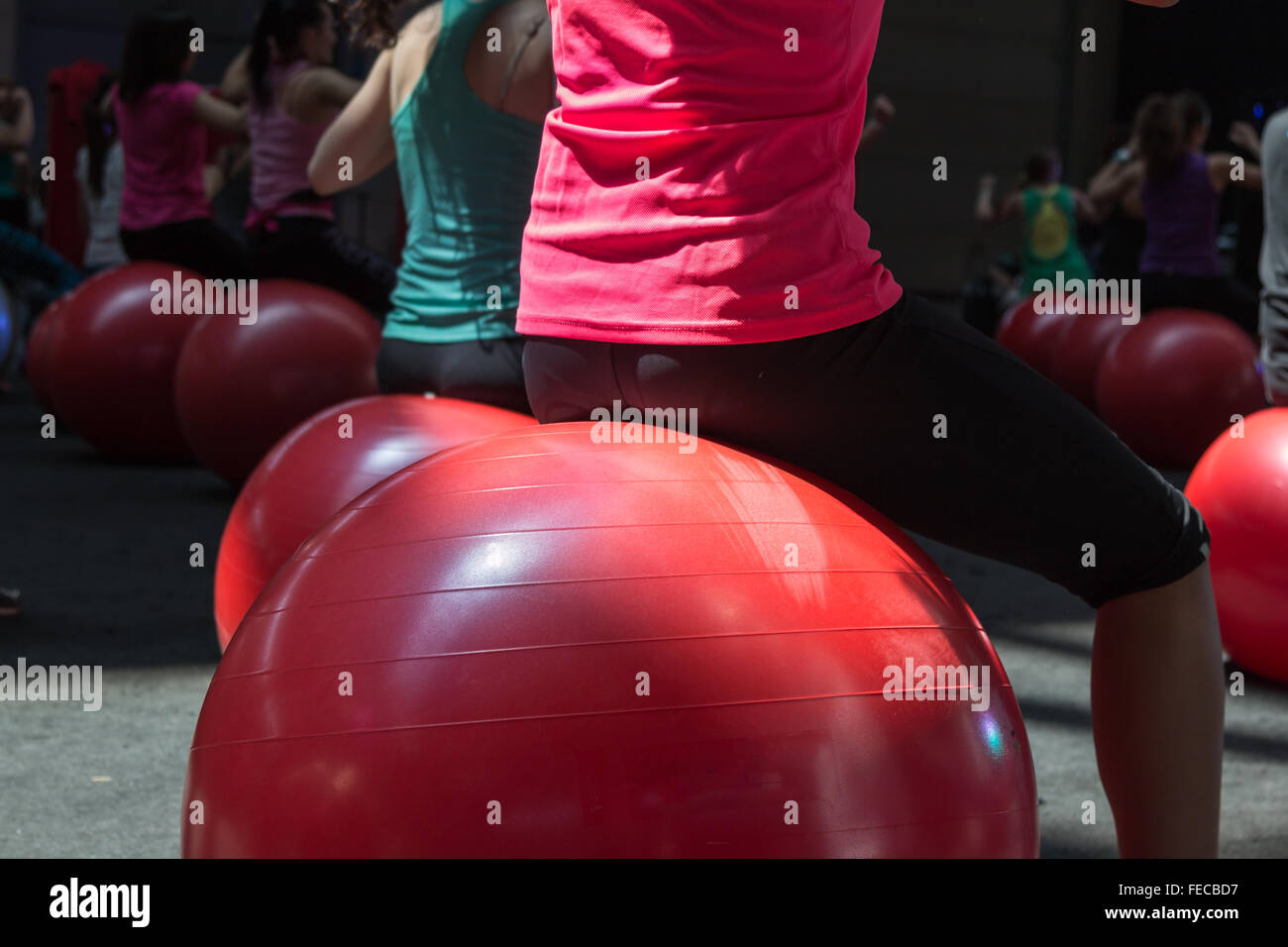 Closeup of Girl doing Fitness Activity Sitting on Big Red Ball in Gym ...
