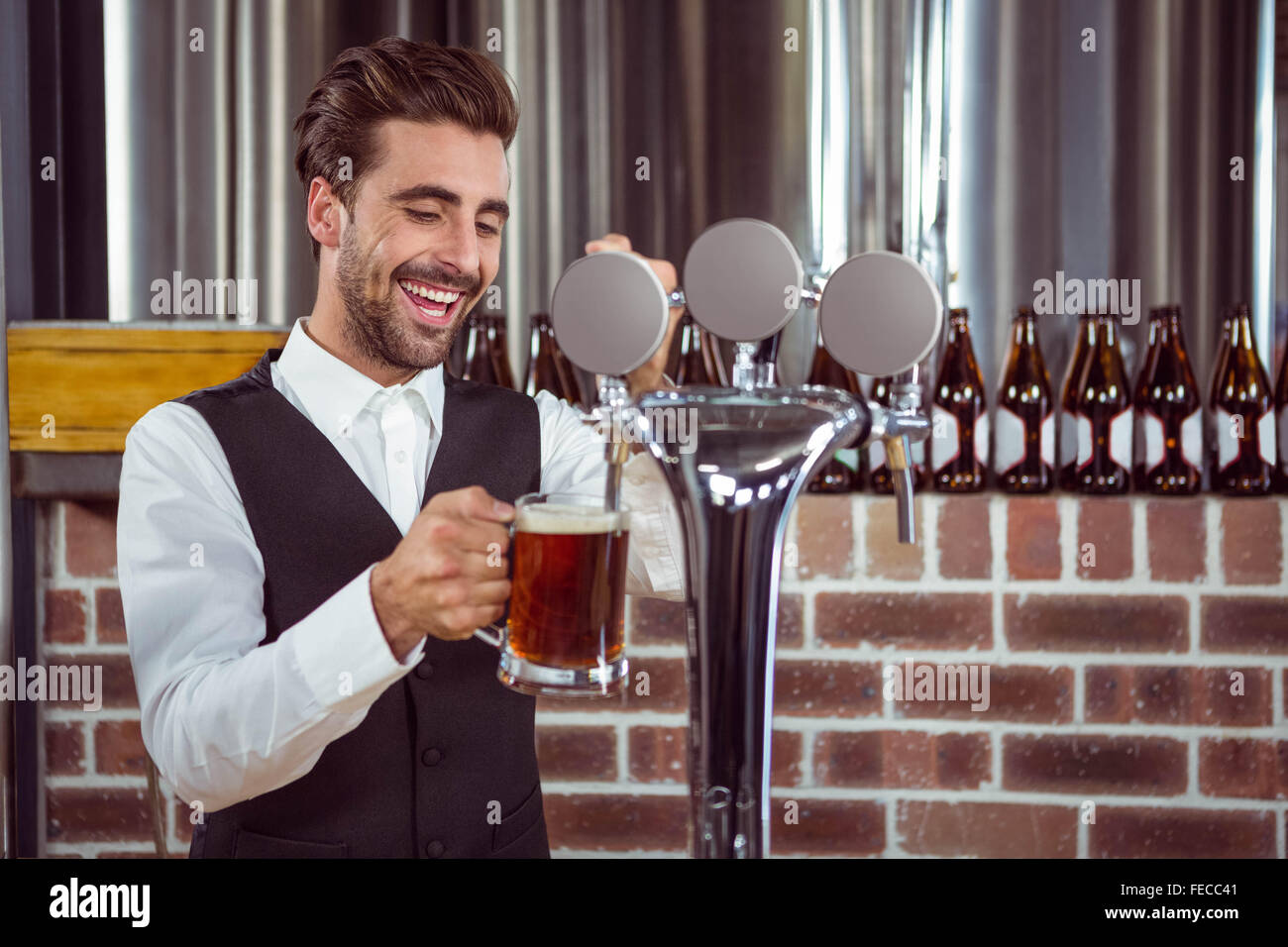 Handsome barman pouring a pint of beer Stock Photo - Alamy