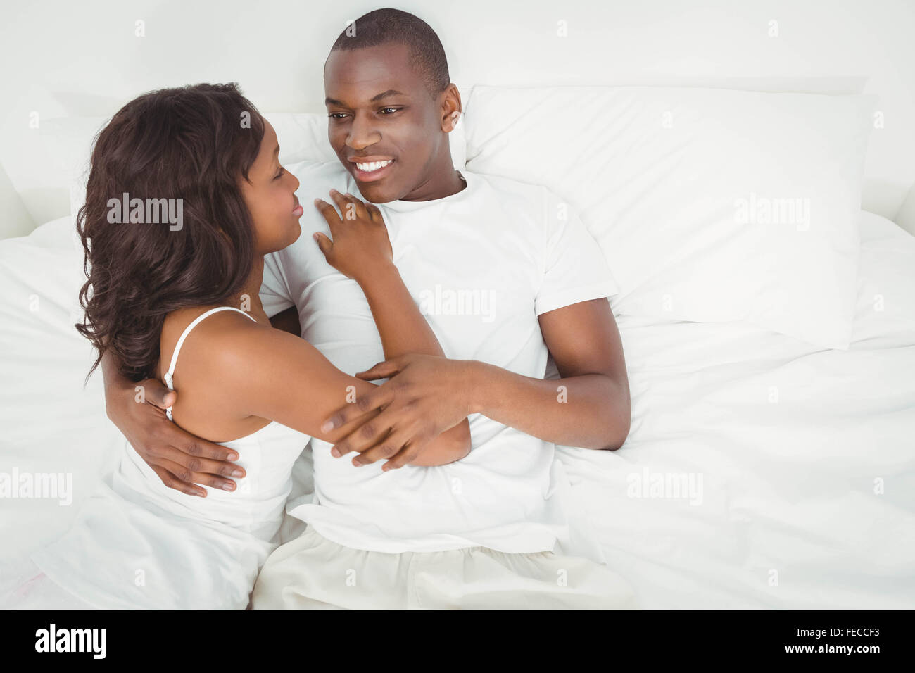 Ethnic couple cuddling Stock Photo - Alamy