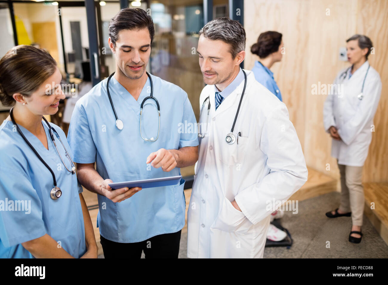 Medical team standing and talking Stock Photo - Alamy