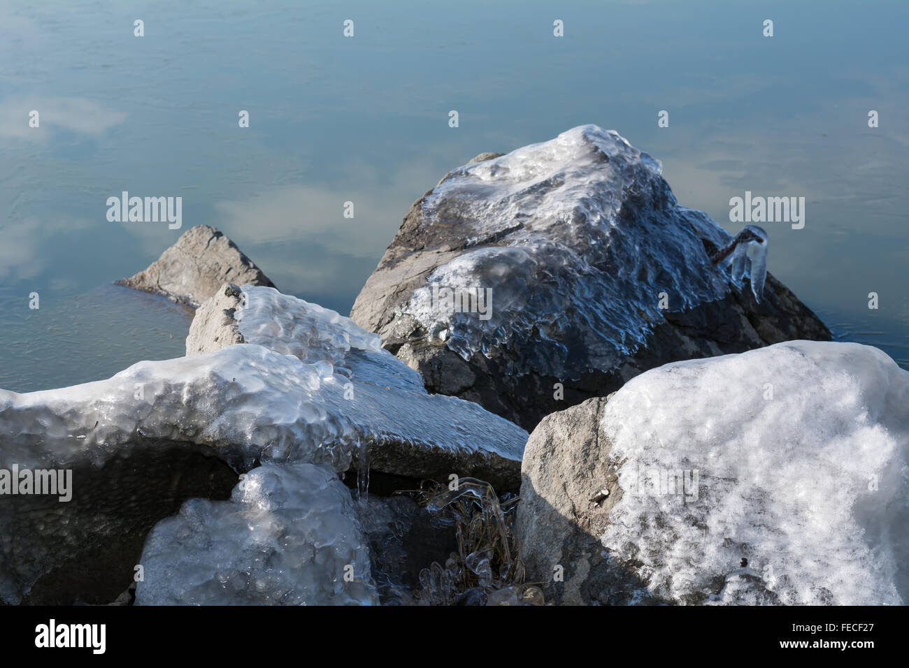 Frozen rocks with ice in the winter lake Stock Photo - Alamy