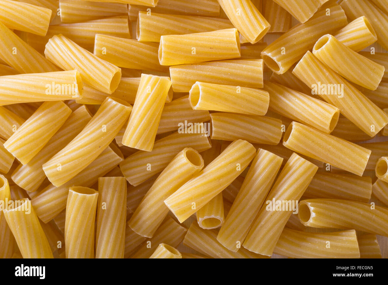 Pasta rigatoni background with small pasta shapes Stock Photo - Alamy