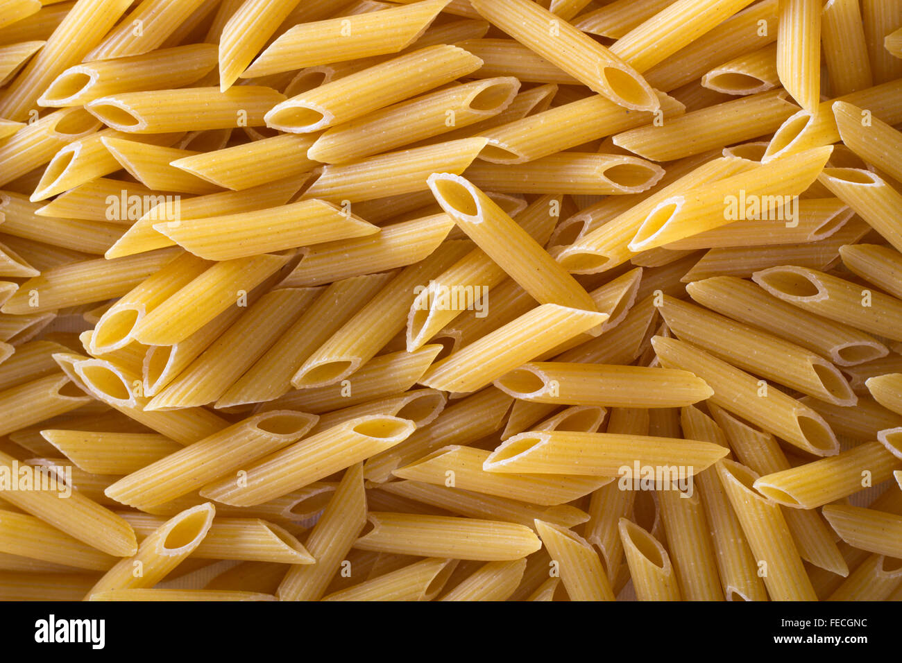 Pasta penne background with small pasta shapes Stock Photo - Alamy