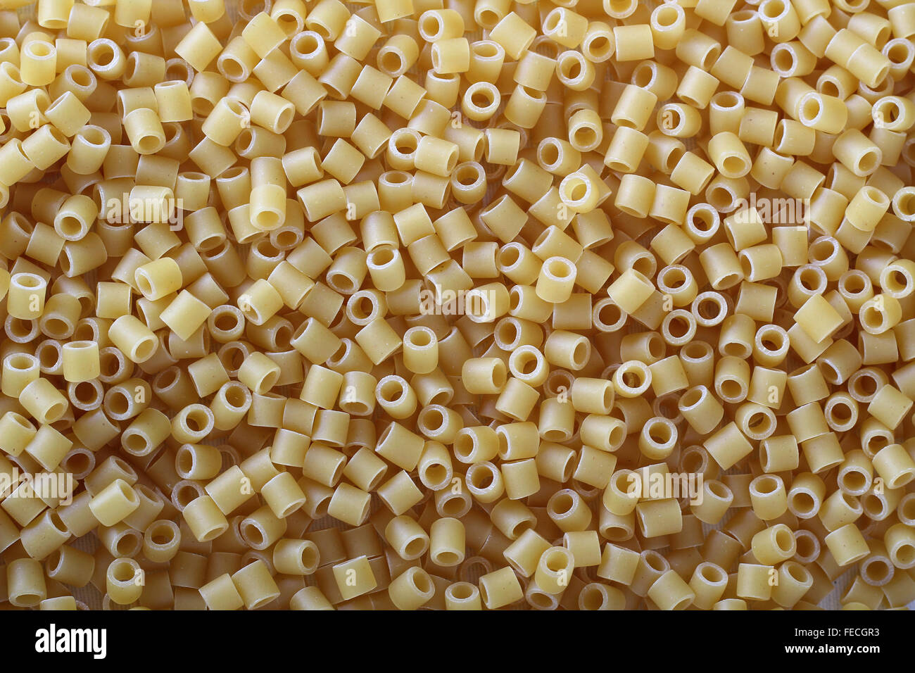 Pasta Ditalini background with small pasta shapes Stock Photo - Alamy
