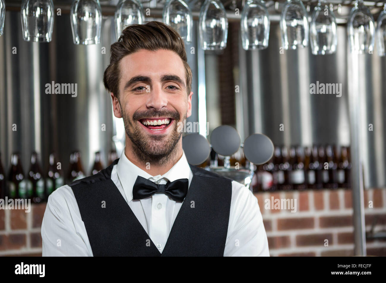 Handsome barman smiling at camera Stock Photo - Alamy