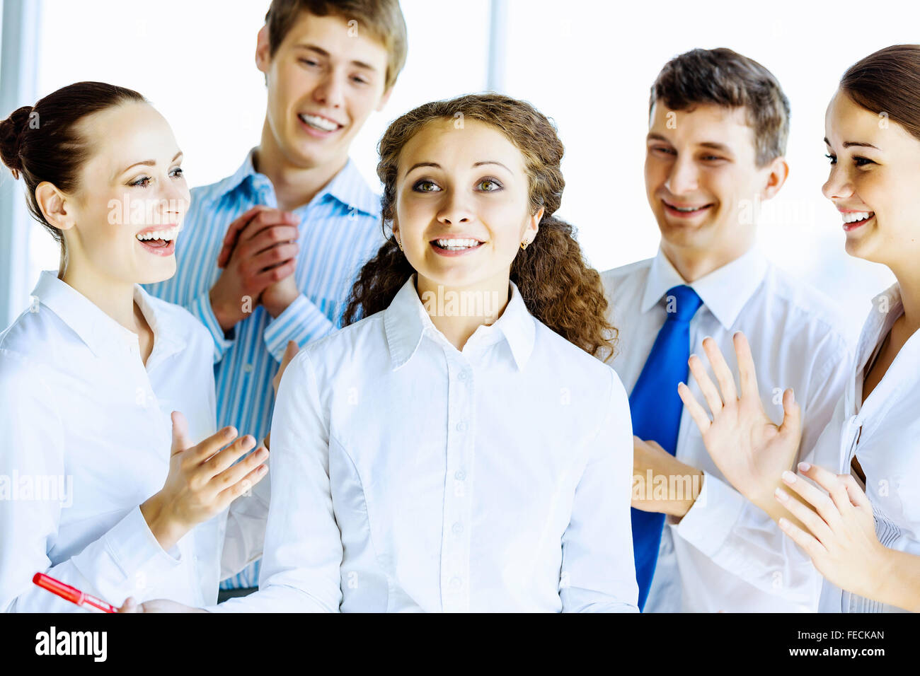 Image of young businesspeople congratulating colleague. Success concept ...