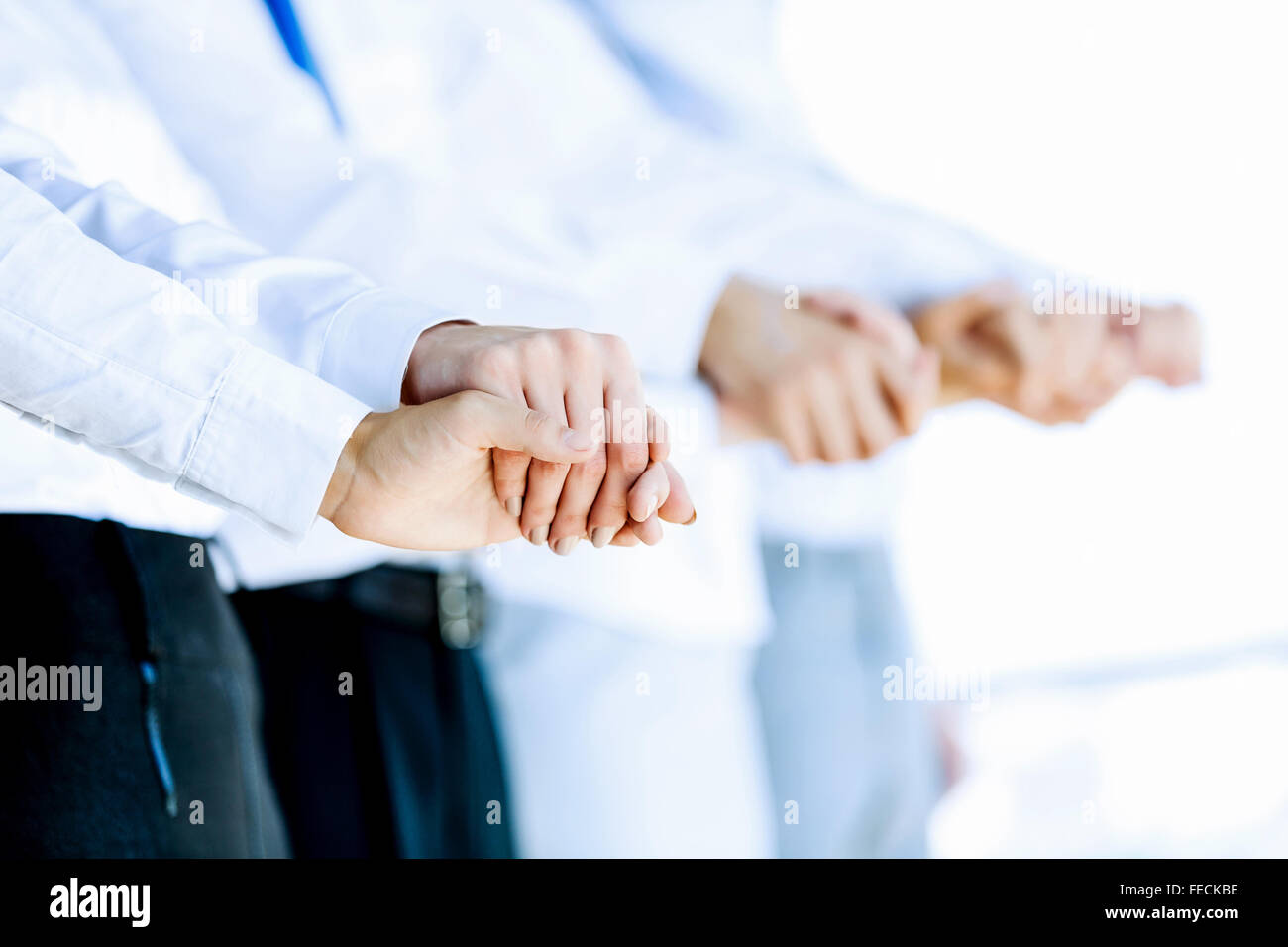 Image of group of businesspeople holding arms together. Teamwork Stock ...