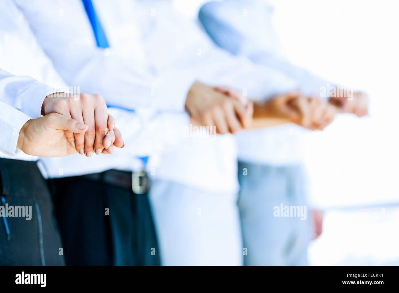 Image of group of businesspeople holding arms together. Teamwork Stock ...
