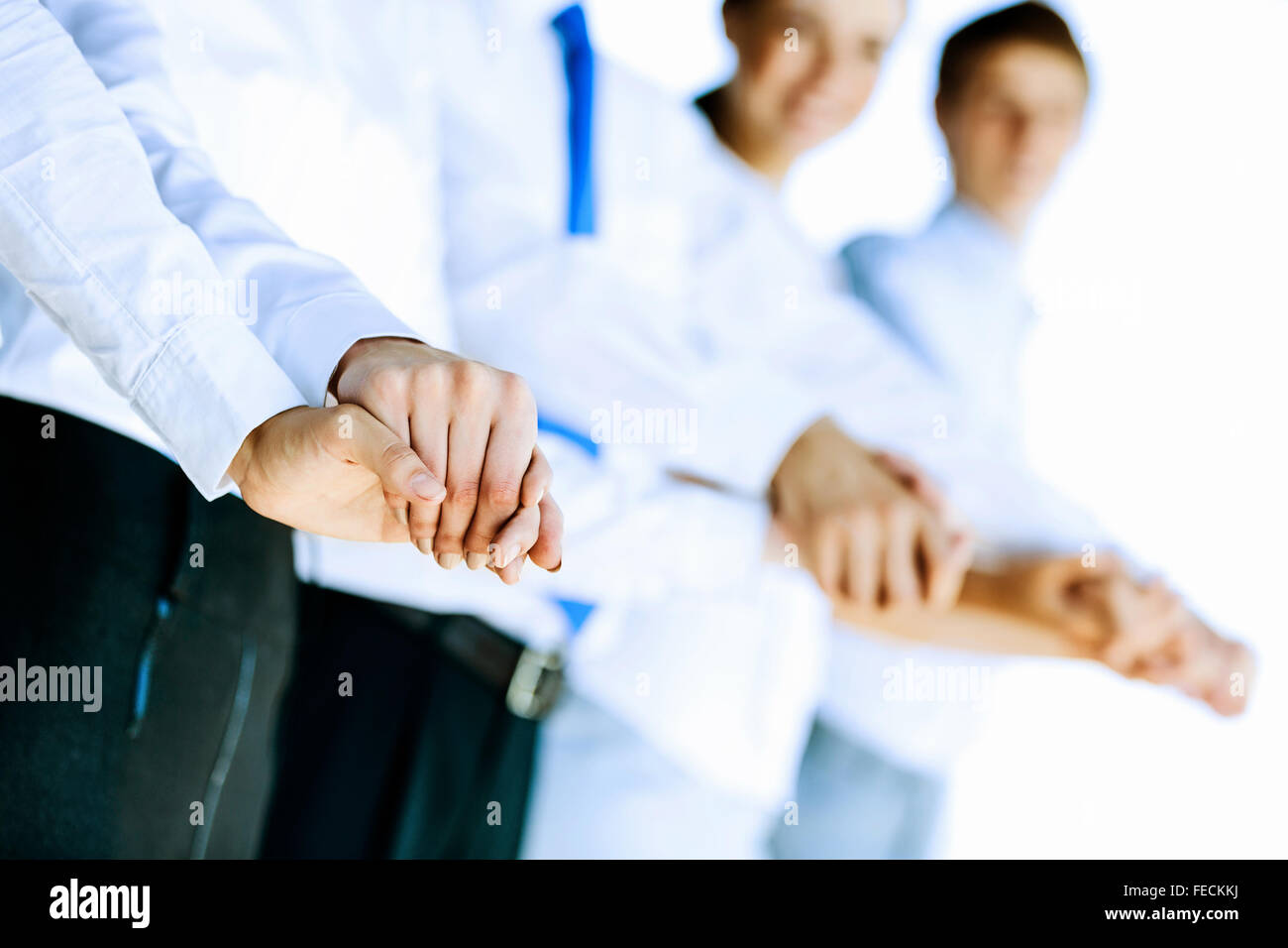 Image of group of businesspeople holding arms together. Teamwork Stock ...