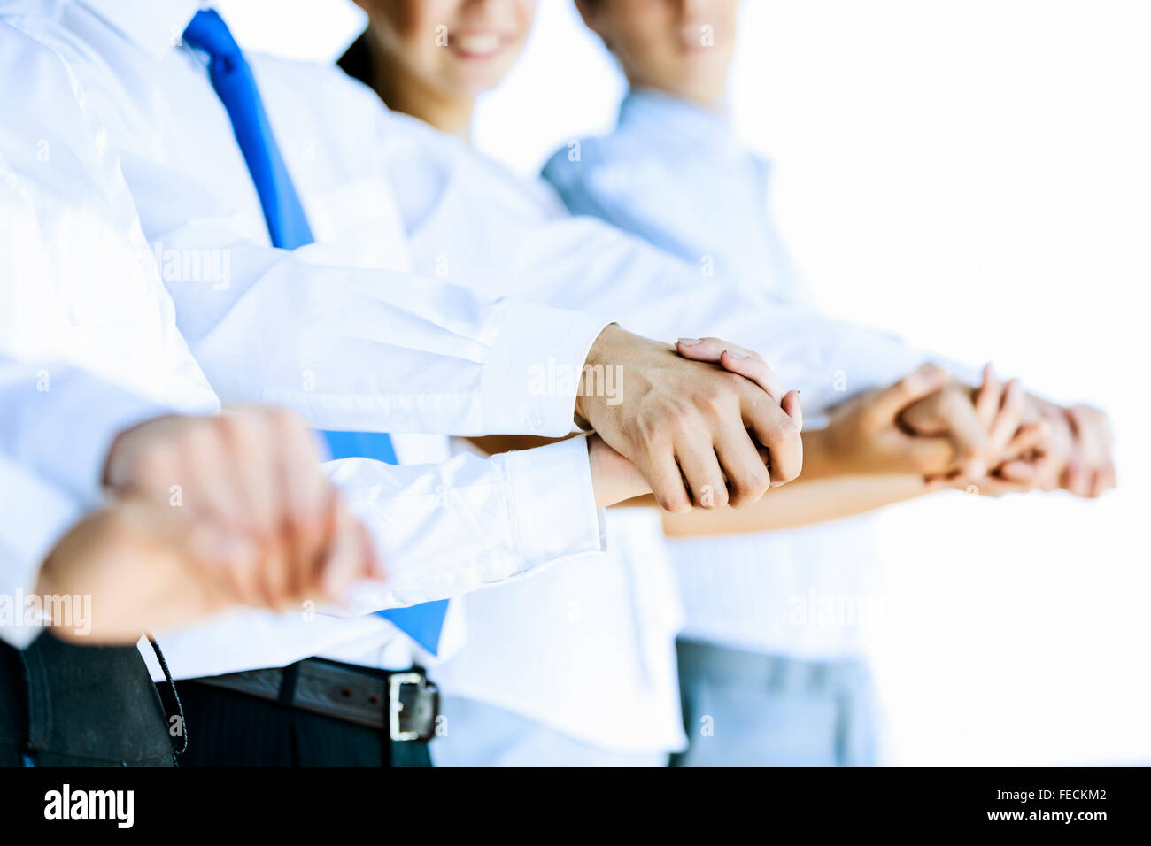 Image of group of businesspeople holding arms together. Teamwork Stock ...